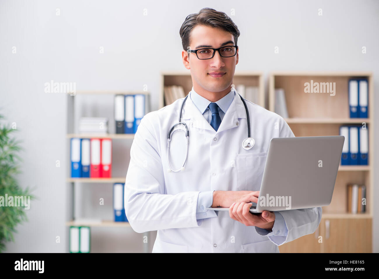 Young adult doctor with laptop computer Stock Photo - Alamy
