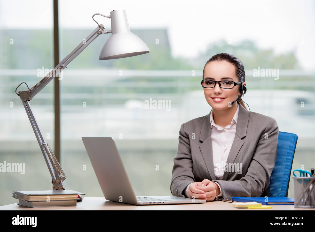 Call center operator working at her desk Stock Photo - Alamy
