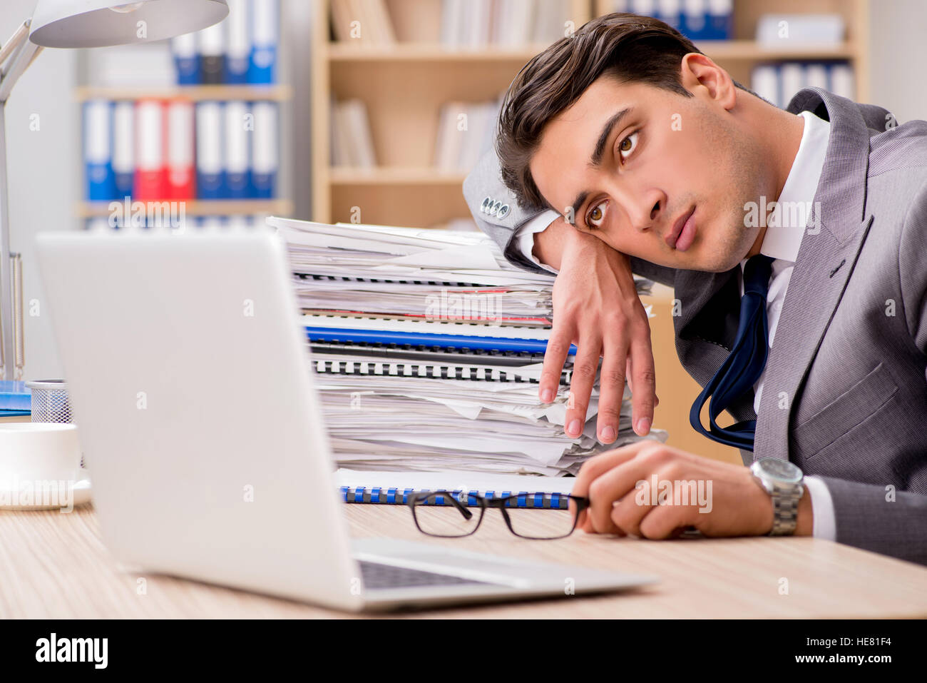 Businessman tired sitting in the office Stock Photo - Alamy