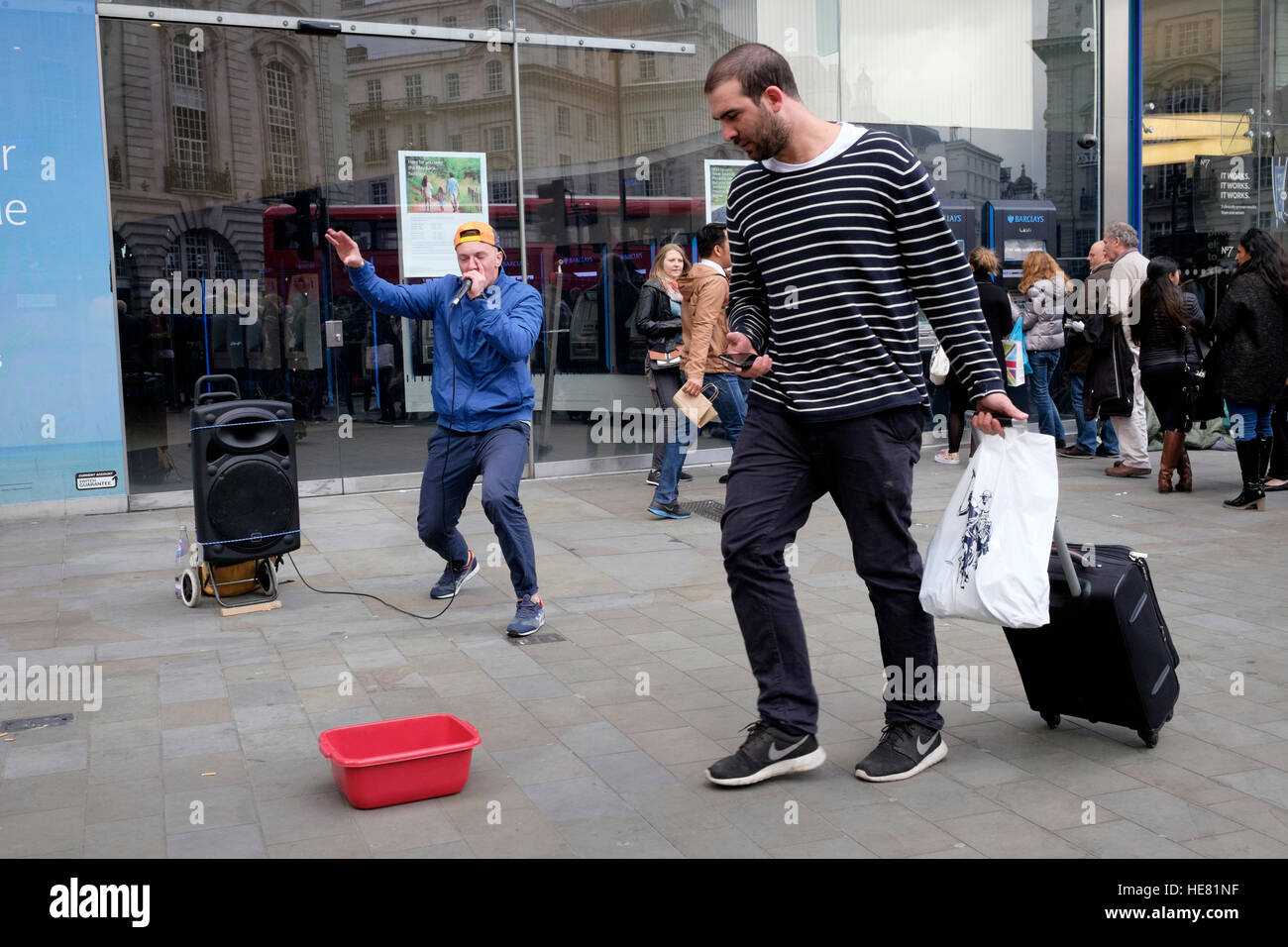 A young street entertainer doing human beatbox on the streets of London ...