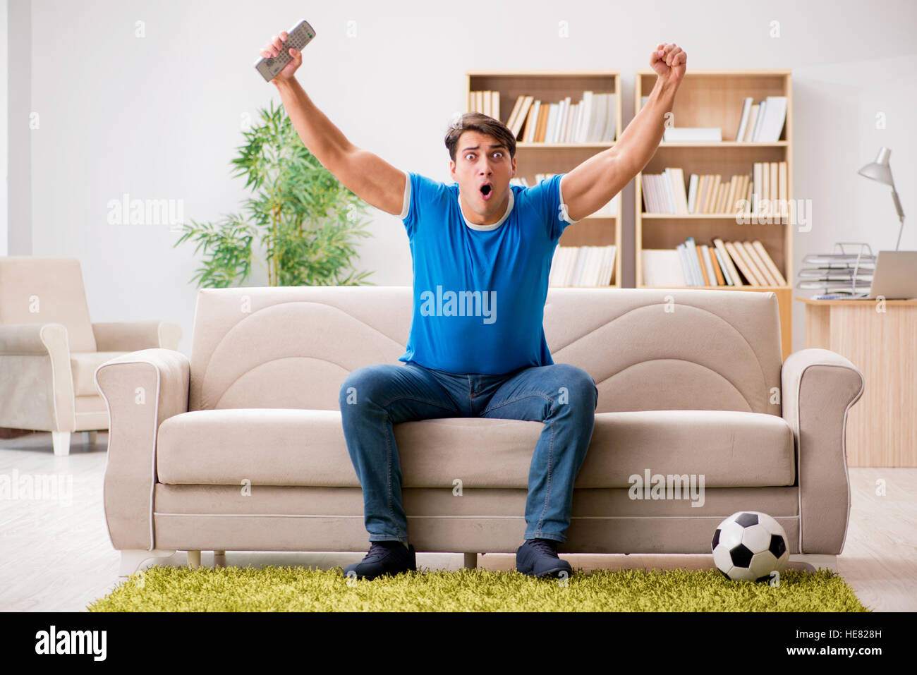 Man watching football at home Stock Photo - Alamy