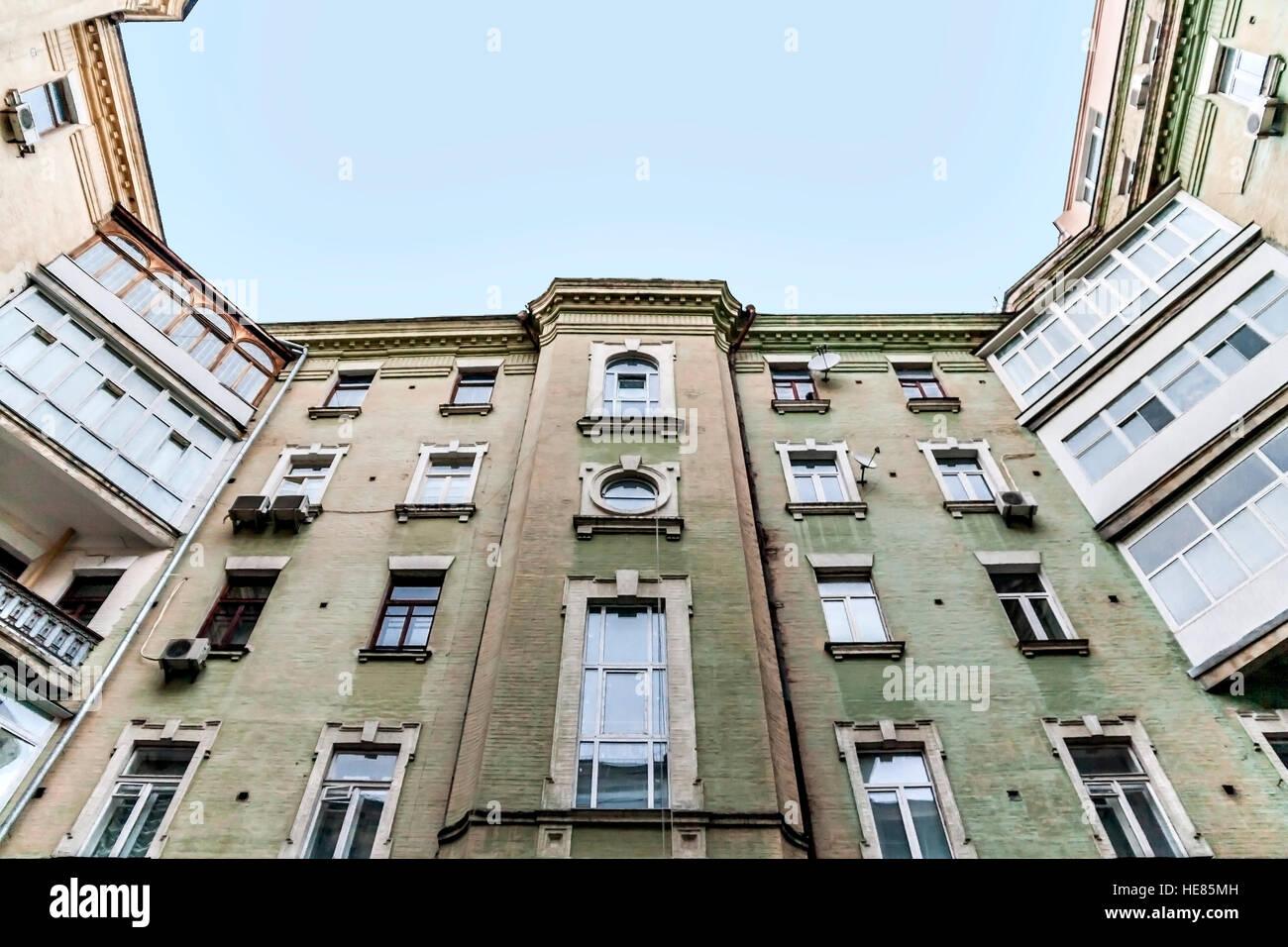 view from the bottom up at the sky, tall old houses, wells, balconies ...