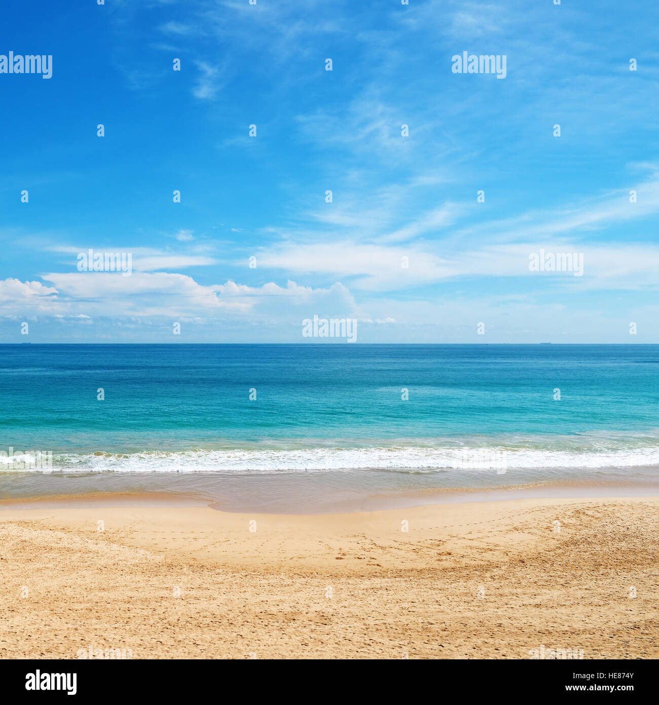ocean, sandy beach and blue sky Stock Photo - Alamy
