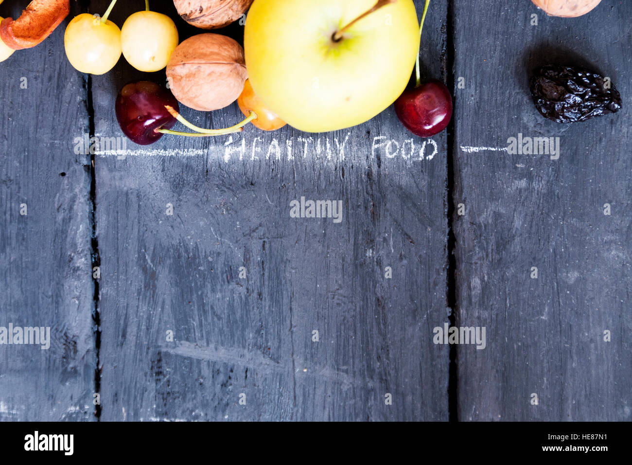 Fruits on rustic table and inscription healthy food Stock Photo - Alamy