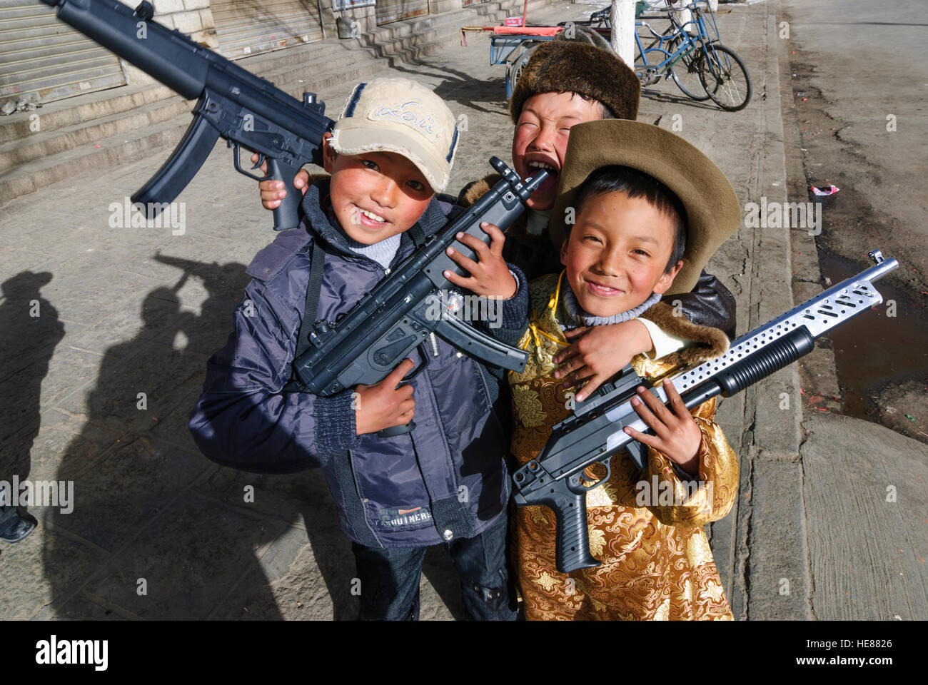 Tibetan children with toy guns hi-res stock photography and images - Alamy