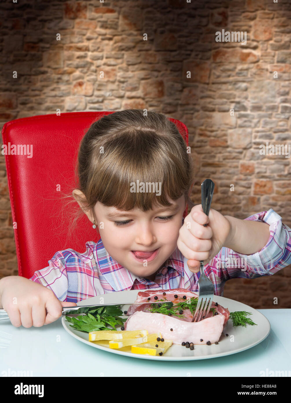 child in the restaurant with a piece of meat Stock Photo - Alamy