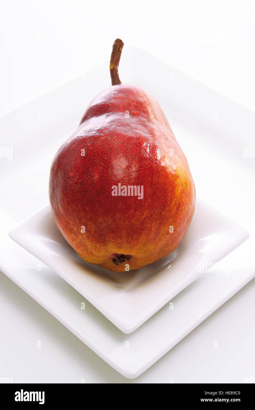Red pear (Red Bartlett) on a plate Stock Photo - Alamy