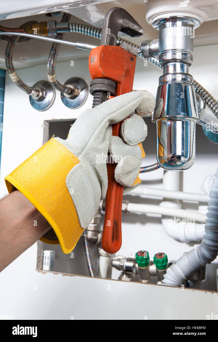 Repairing a pipe under sink. Plumber Stock Photo - Alamy