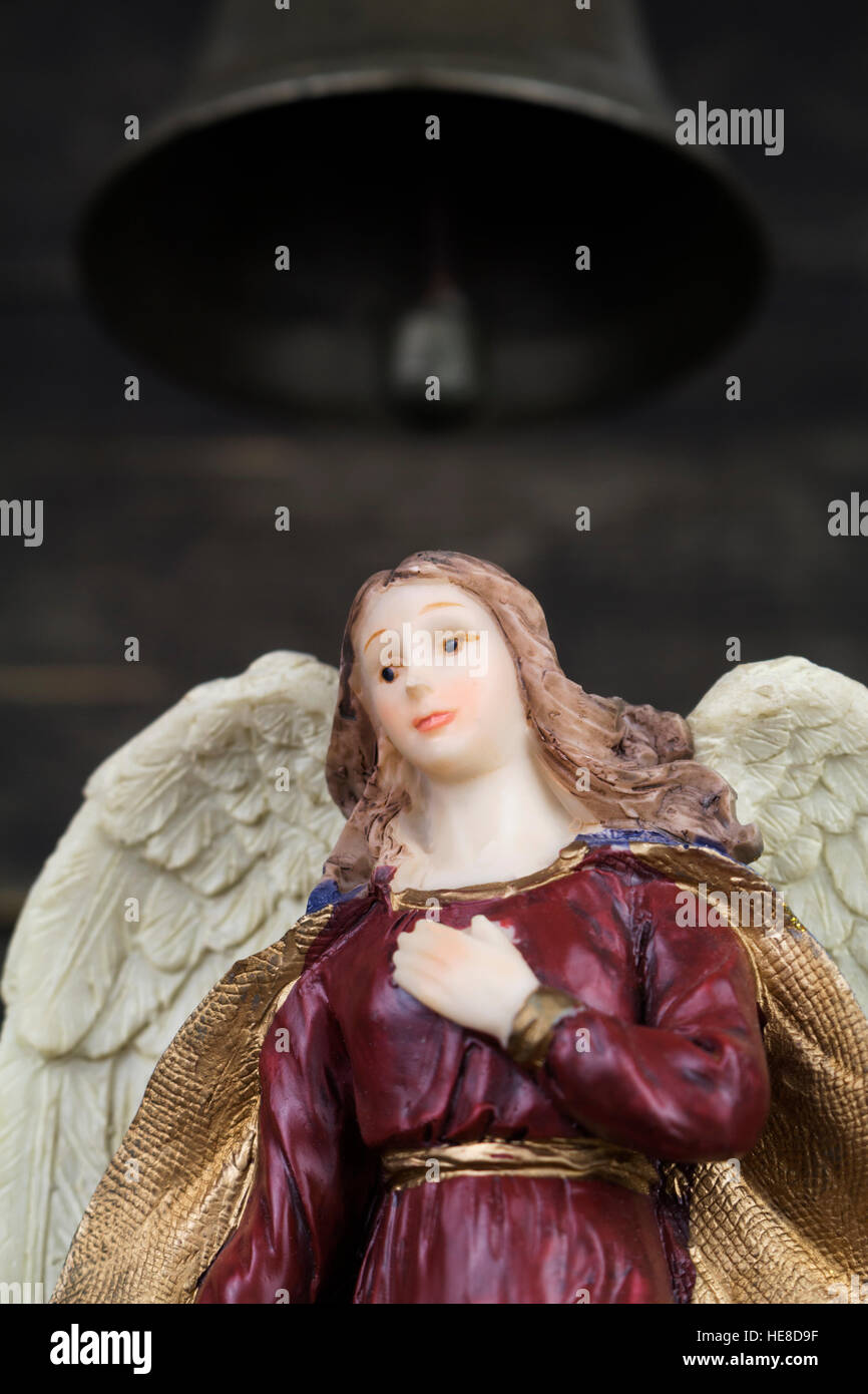 Angel Figurine with White Wings Standing Beneath Church Bell Stock ...