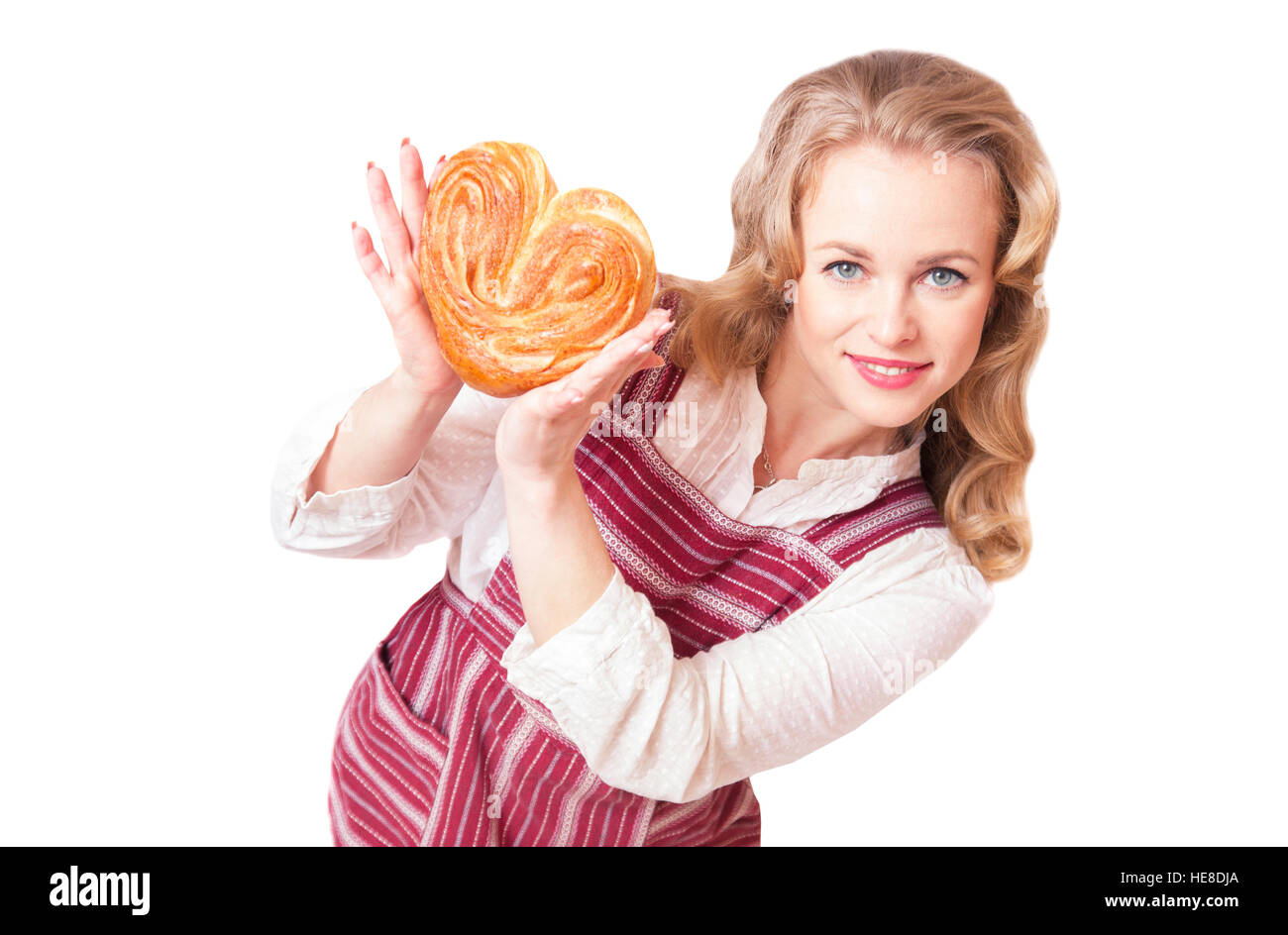 Portrait of cute smiling woman with pastries in her hands in the studio ...