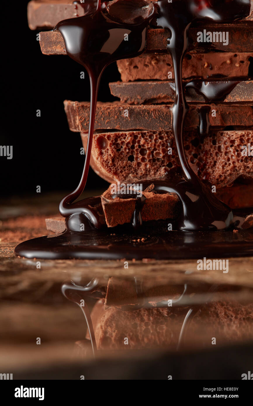 chocolate syrup dripping on stack dark chocolate Stock Photo - Alamy