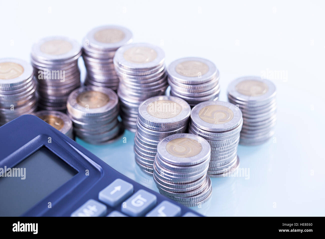 counting income, pile of money, calculator in white background Stock ...