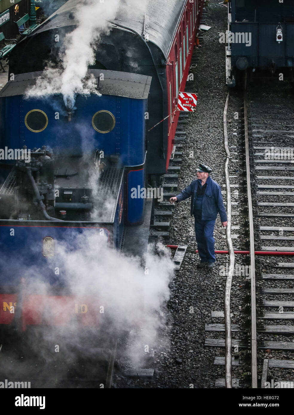 A volunteer with a Sentinel 040 Vertical Boiler Steam train operated by ...