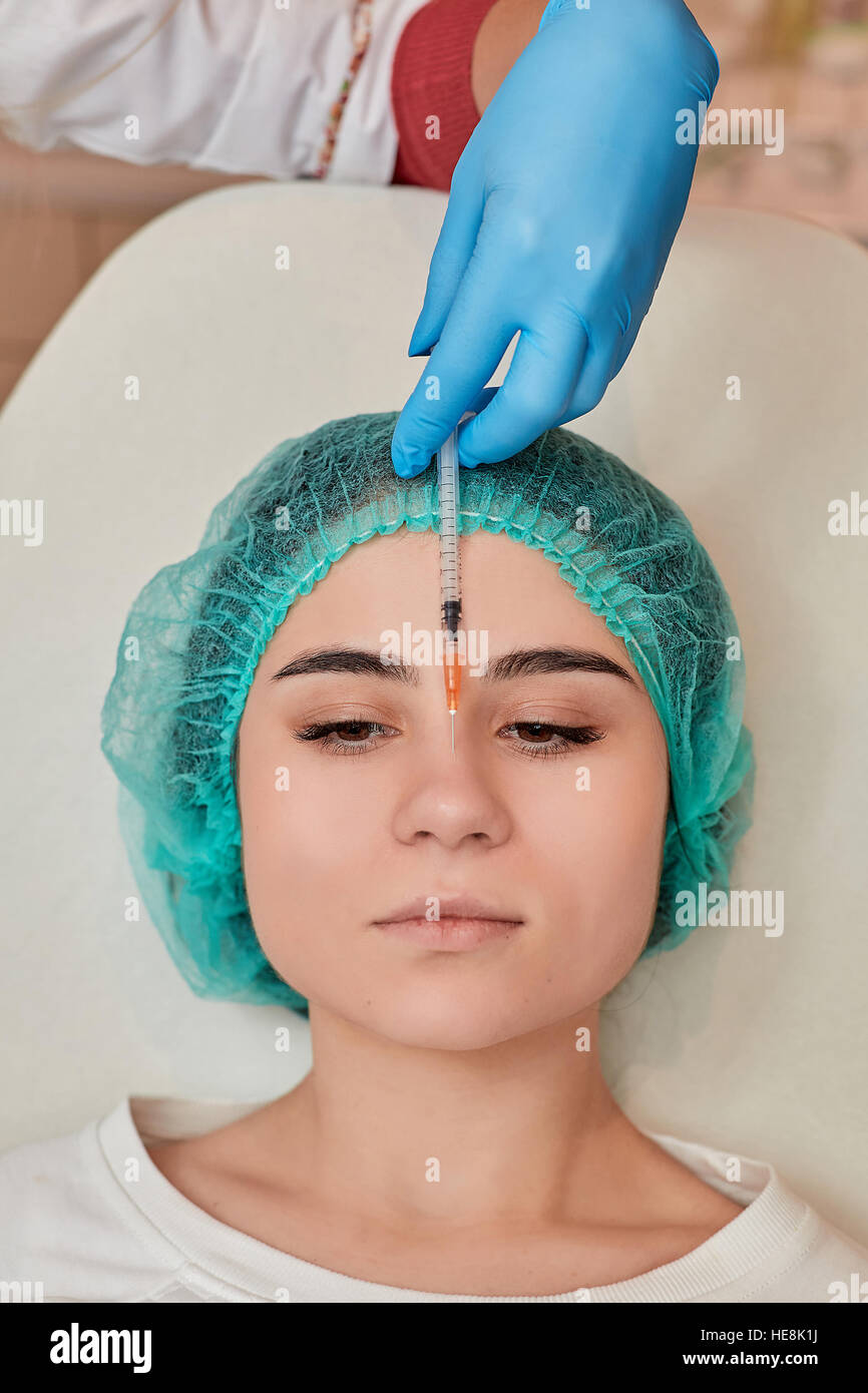 Woman receiving cosmetic injection through nose Stock Photo - Alamy