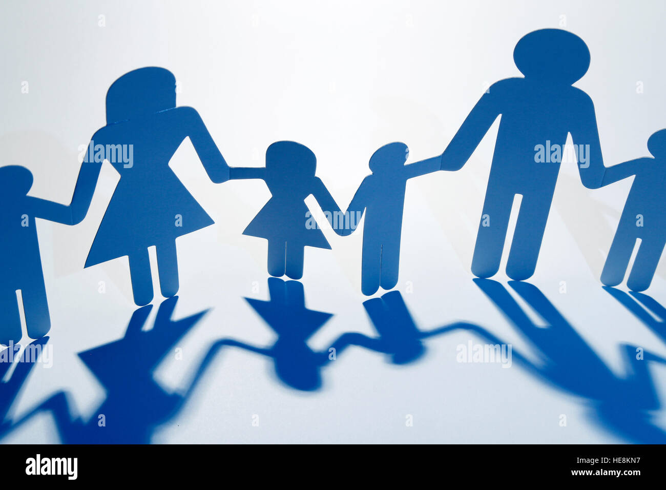 Family paper chain cutout holding hands Stock Photo - Alamy