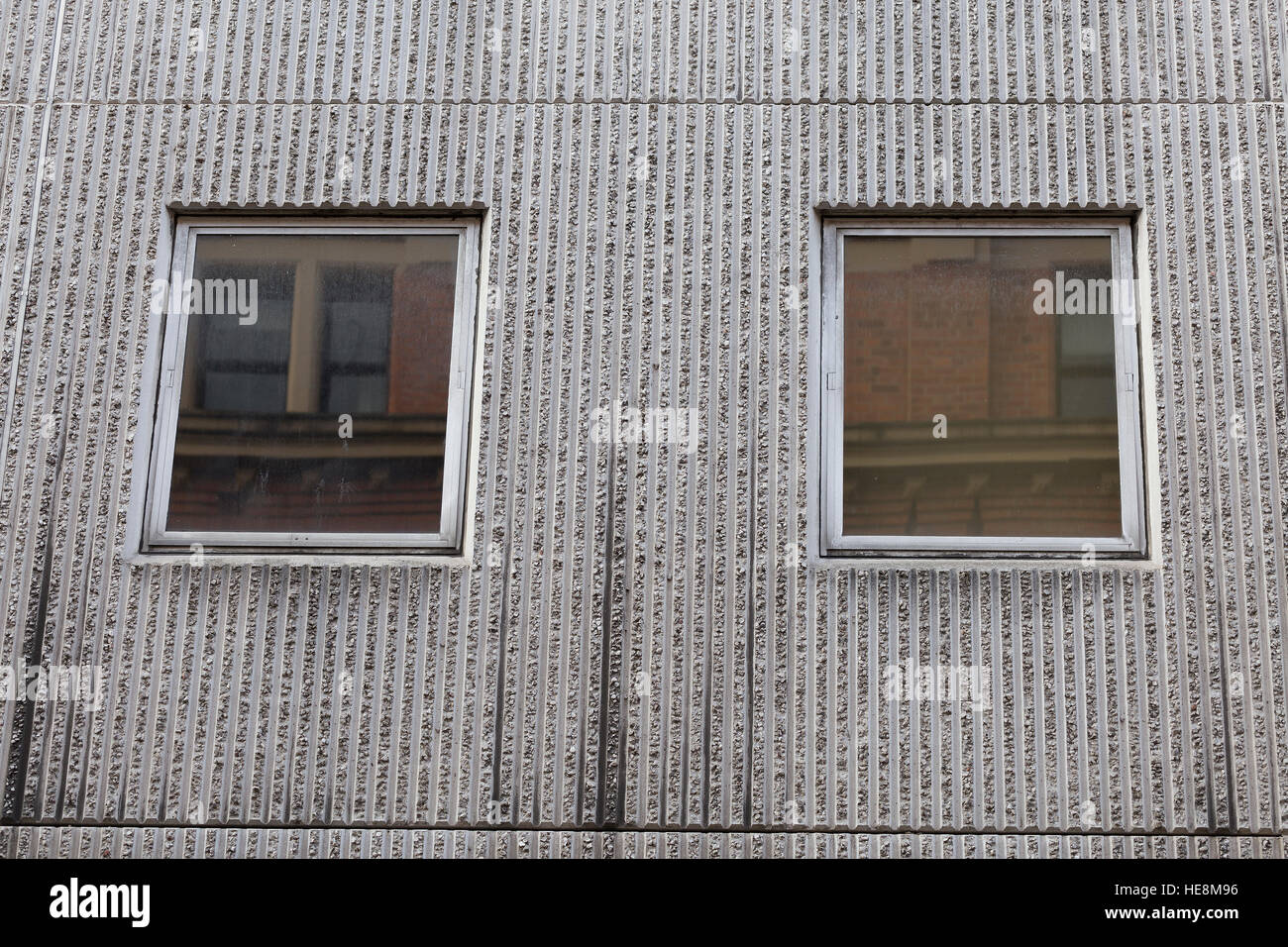 Concrete stripe style brutalist office building with two square windows ...
