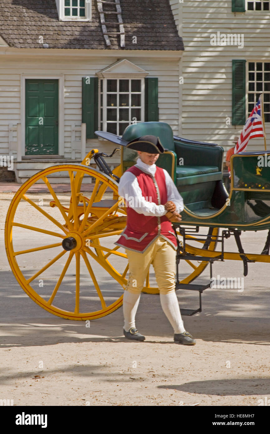Carriage driver standing by there open horse drawn carriage along the ...