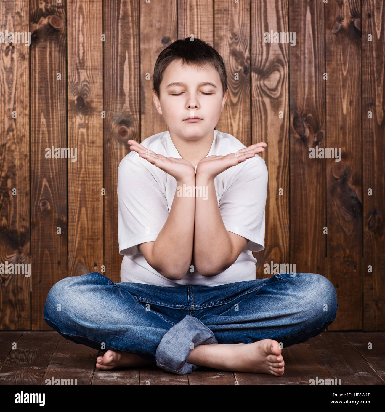 Boy in a suit in lotus position Stock Photo - Alamy