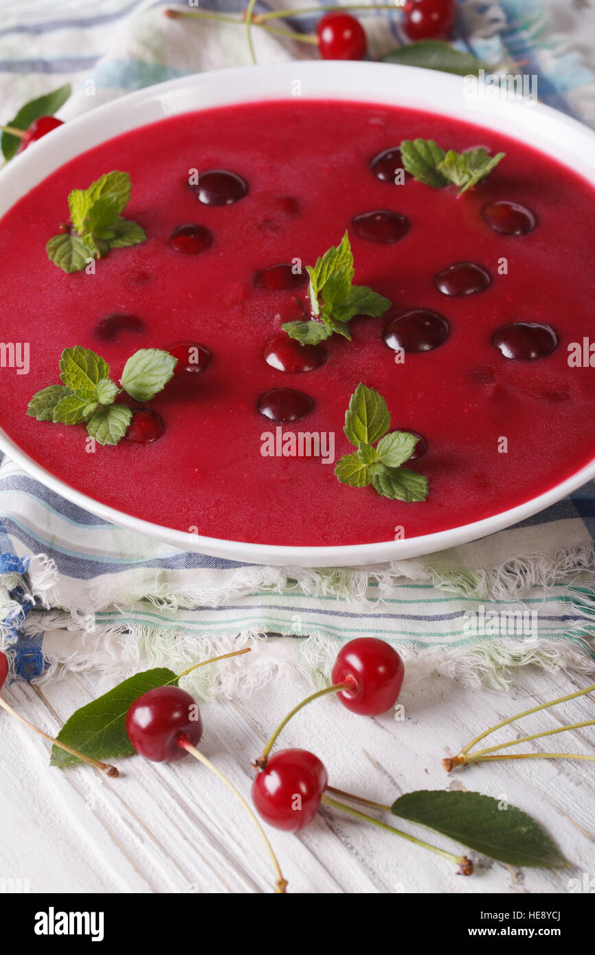 Hungarian cold cherry soup in a bowl on a table close-up. vertical ...