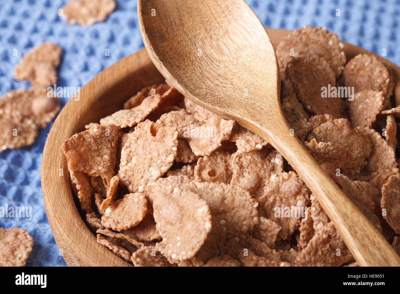 Dietary breakfast: bran flakes in a wooden bowl closeup. horizontal ...