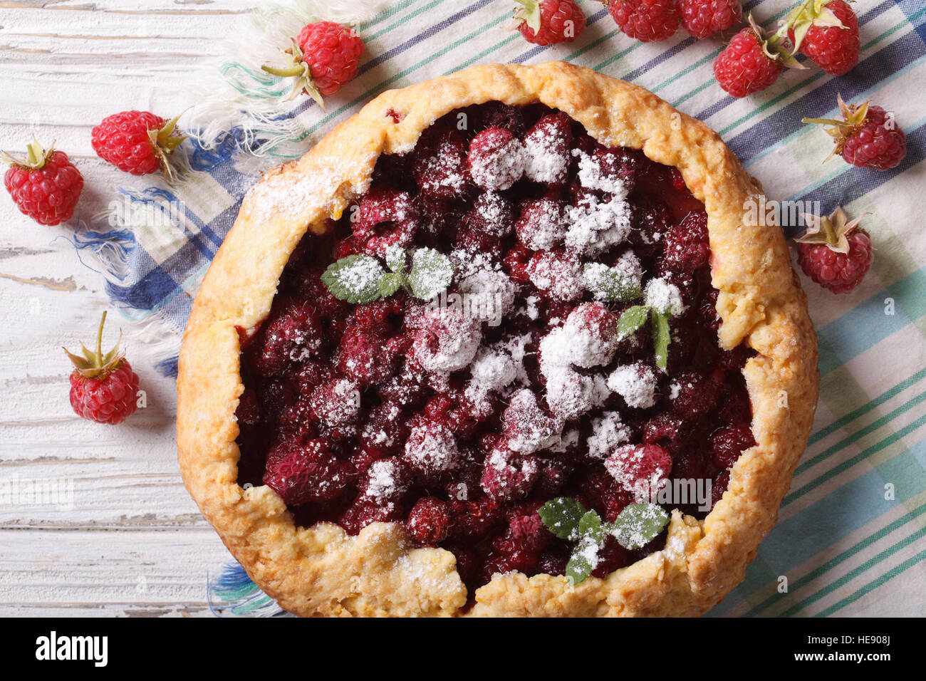 Summer pie with raspberries and mint close-up on the table. horizontal ...
