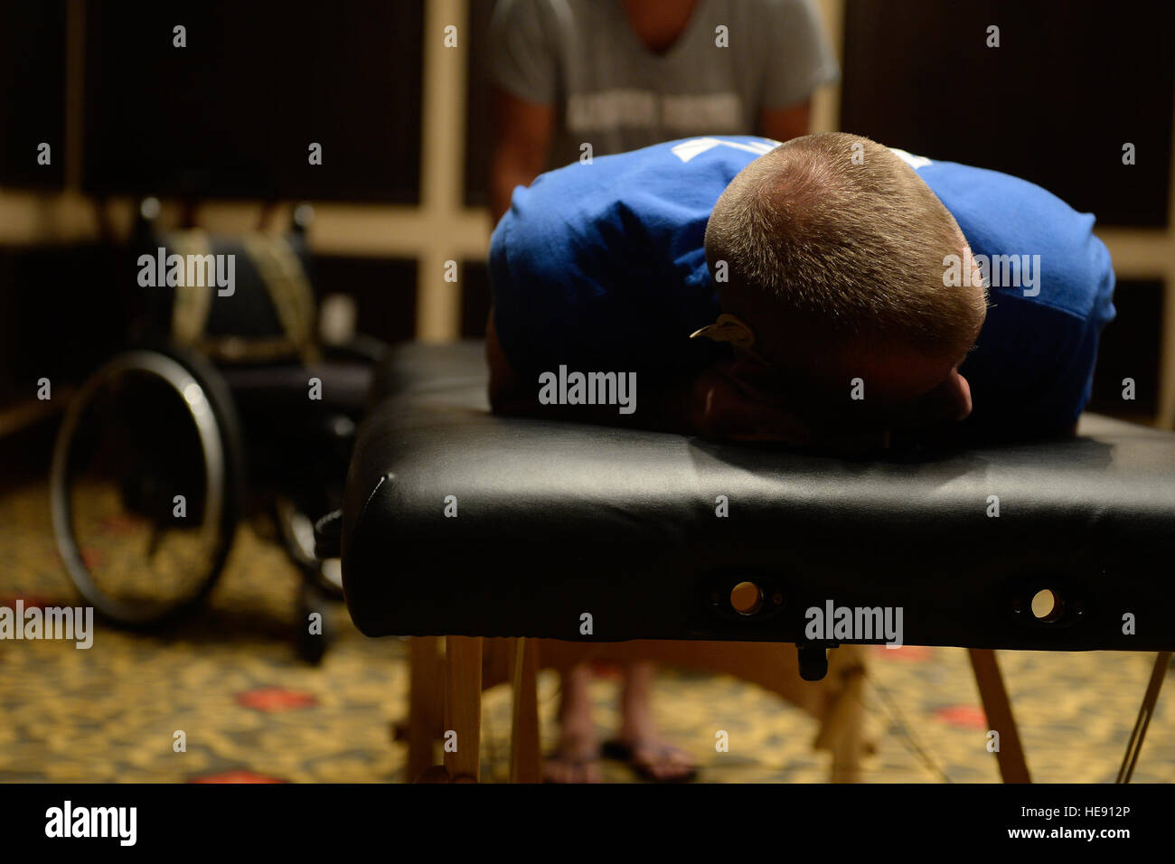Jeremiah Means, Wounded Warrior athlete, conducts an evaluation for ...