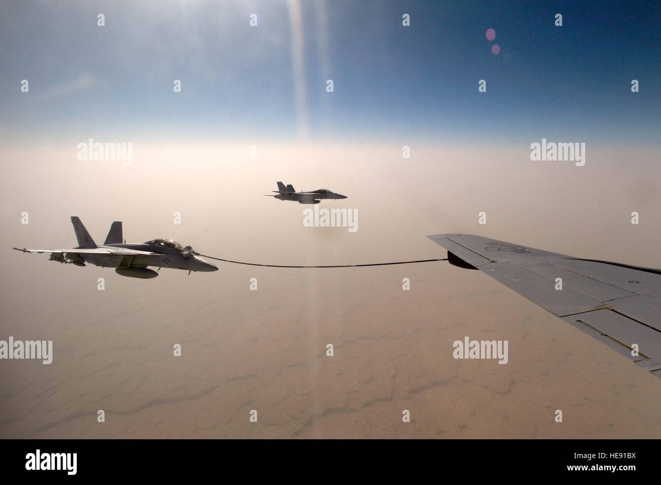 A U.S. Navy F/A-18 Super Hornet receives fuel via the multi-point ...