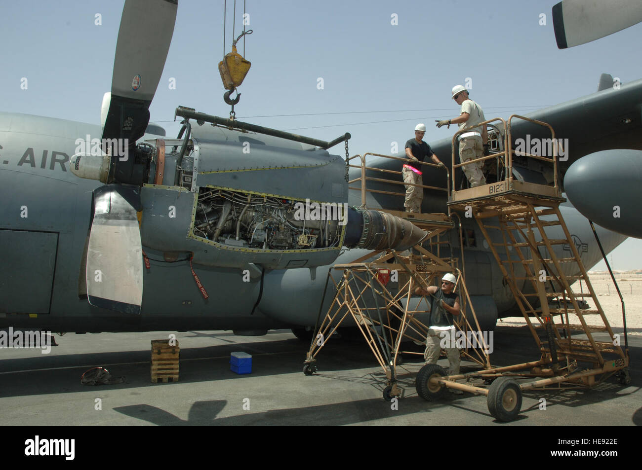 Members of the 746th Aircraft Maintenance Unit guide an engine into ...