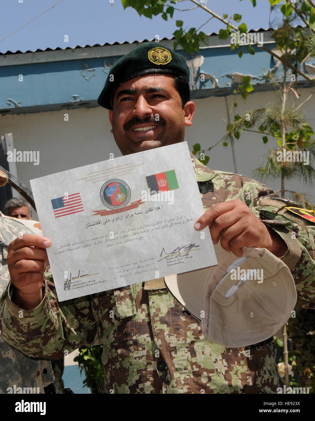 An Afghan National Army soldier proudly displays his graduation ...