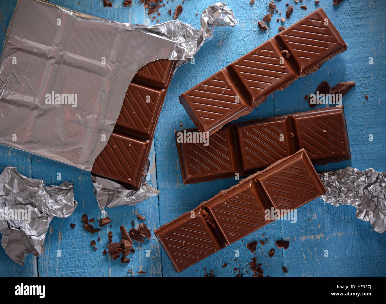 the chocolate bar on blue wood table Stock Photo - Alamy