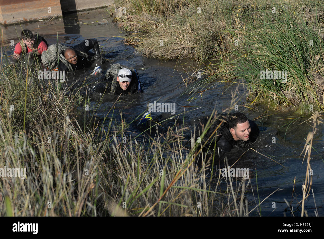 Members of Altus AFB high crawl through water in a GORUCK Light ...