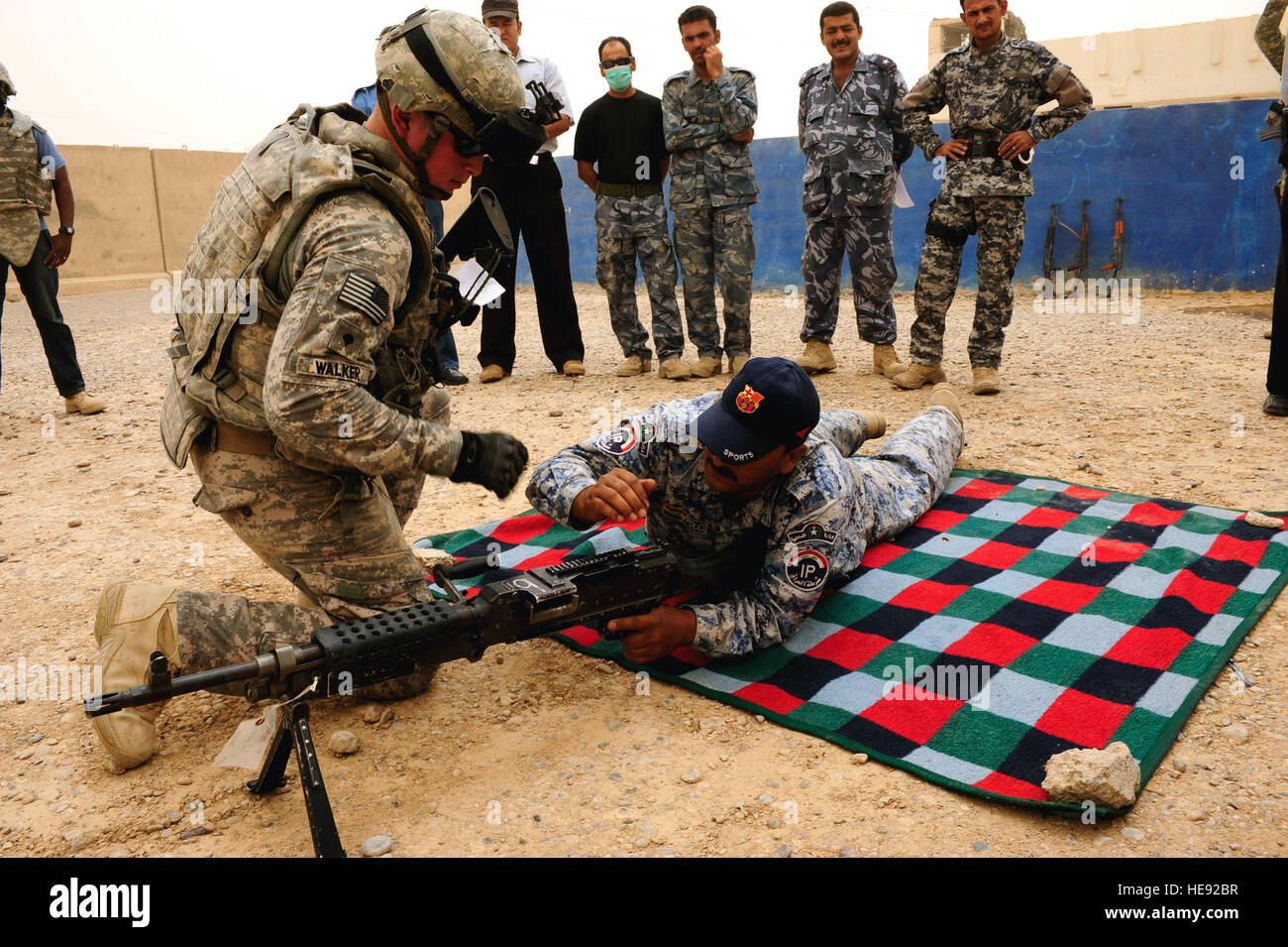 An Iraqi police officer demonstrates proper clearing procedures on an ...