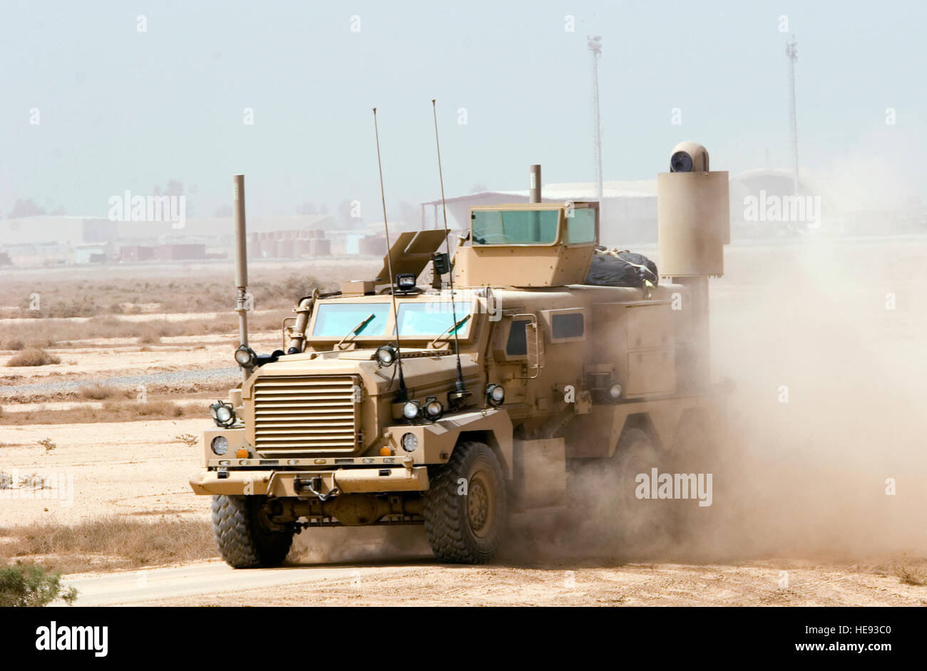 A Mine Resistant Ambush Protected, or MRAP, vehicle drives toward a ...