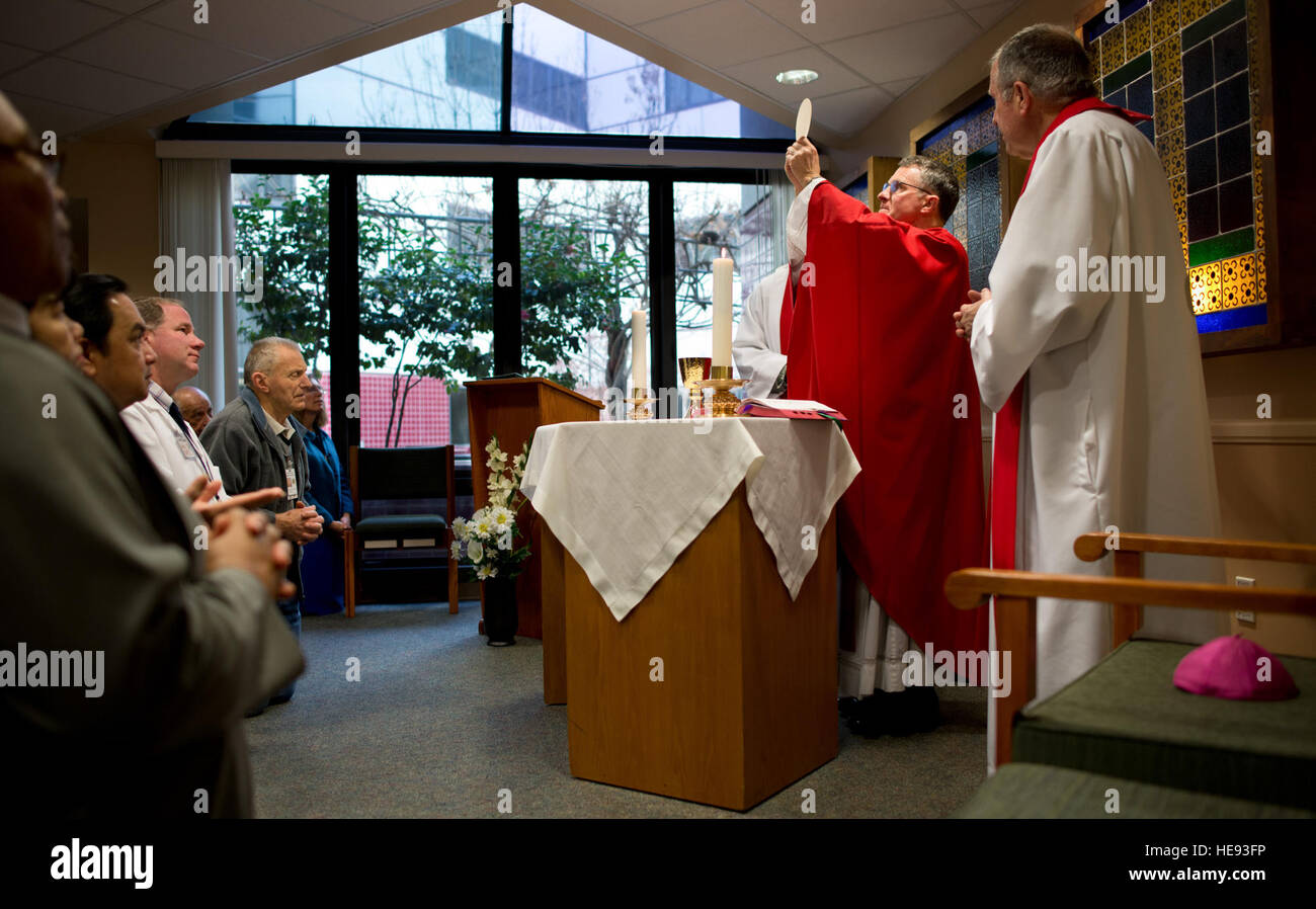 A representative of the military archdiocese administers communion at ...