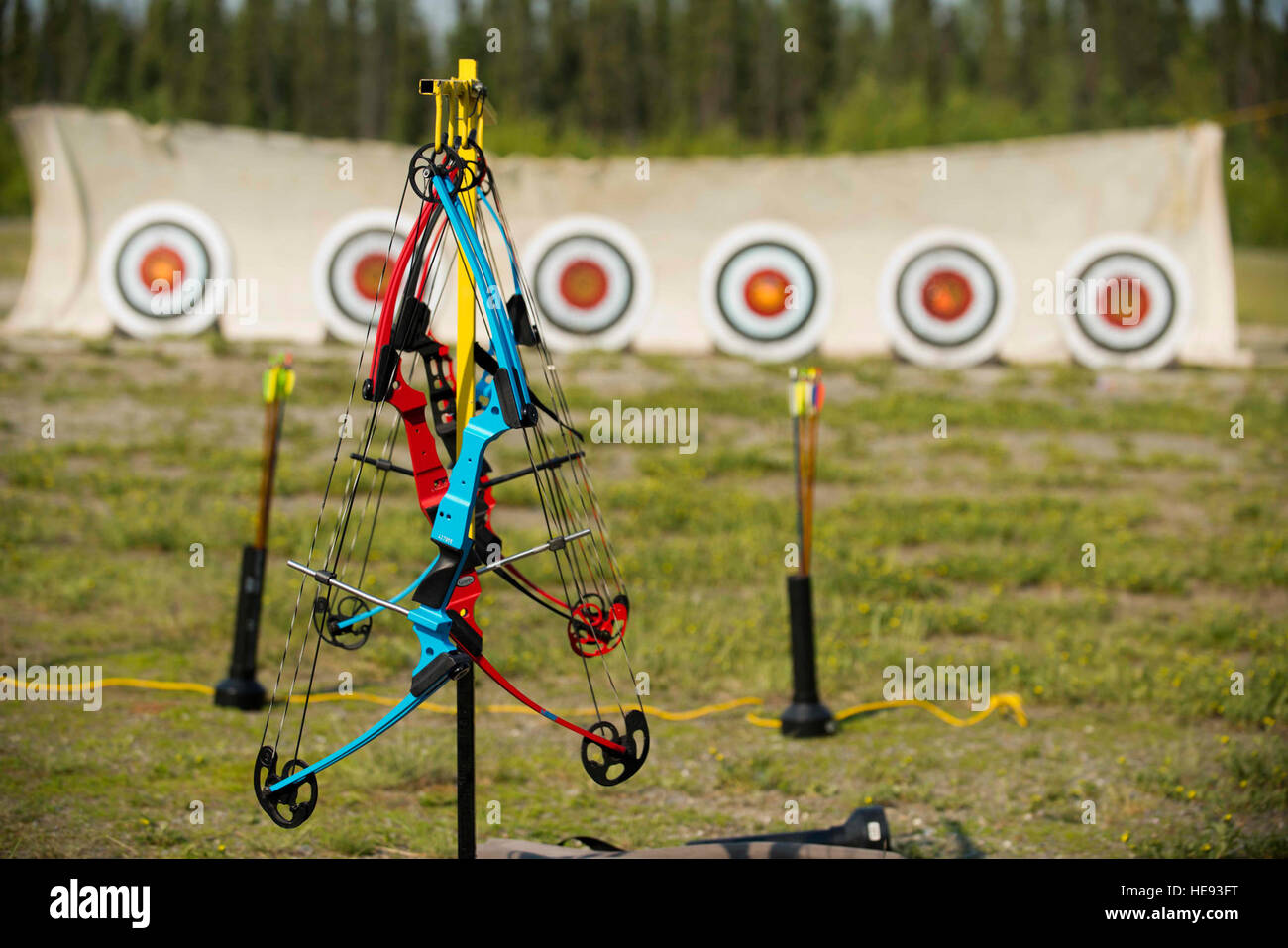 Compound bows hang ready to be used during an archery class at the ...