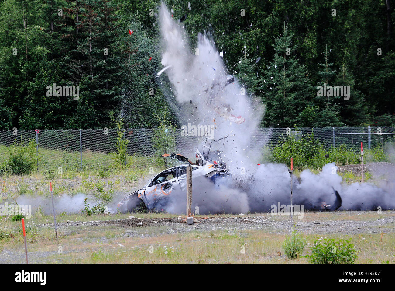 An explosive device is control-detonated under a car to demonstrate the ...
