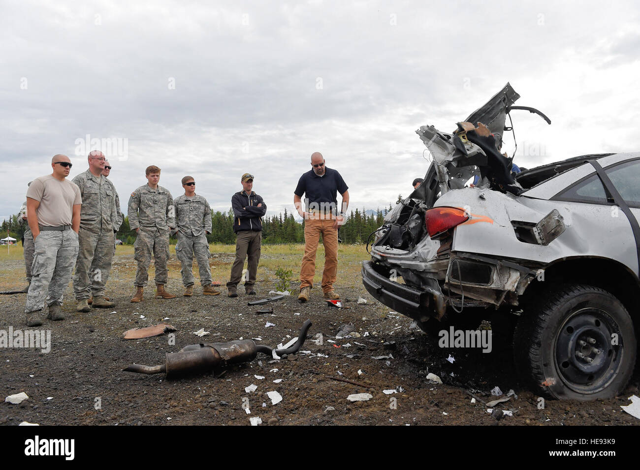 Air Force and Army explosive ordnance disposal technicians examine the ...