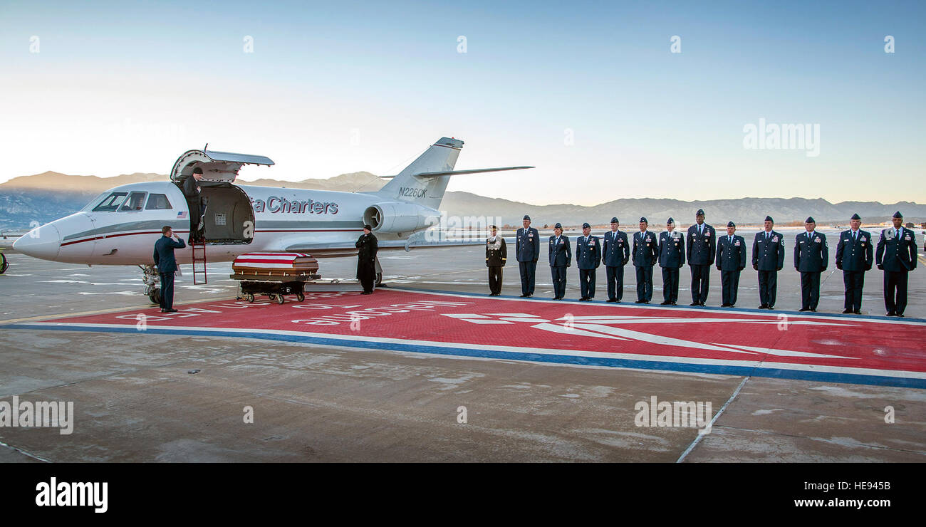U.S. Airmen stand at attention as a casket containing the remains of ...