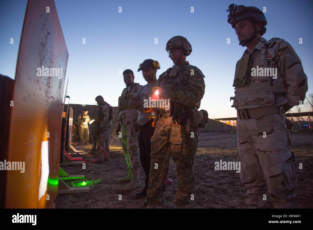 An Australian soldier, center, assigned to Task Group Taji, and an ...