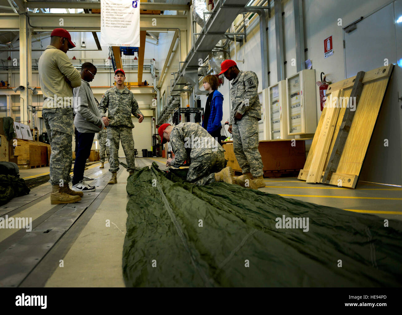 U.S. Army parachute riggers show Aviano Middle/High School students a ...