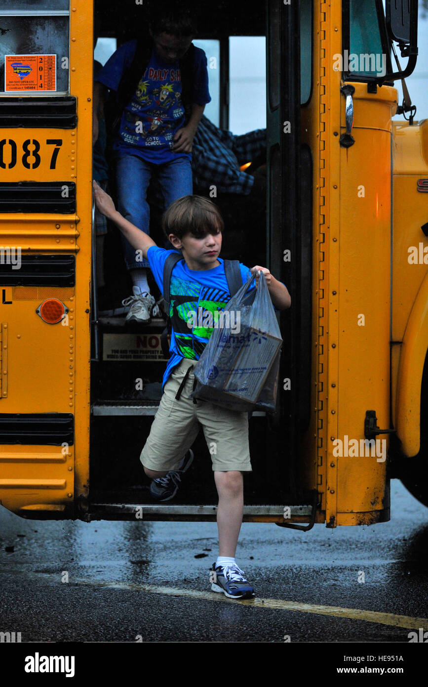 A child steps off a school bus on the first day of school at Shaw ...