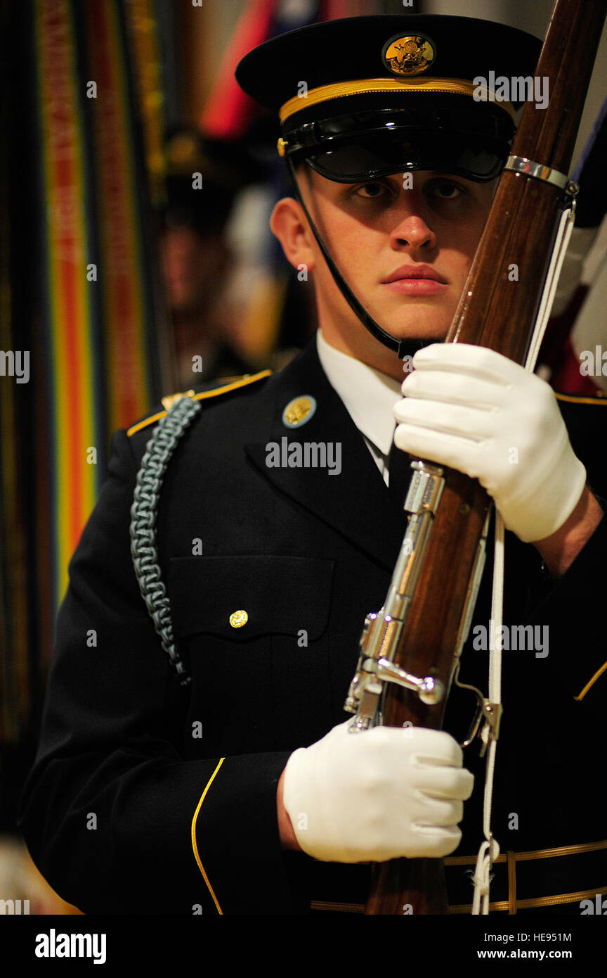 A color guard member prepares to post the colors during a ceremony ...