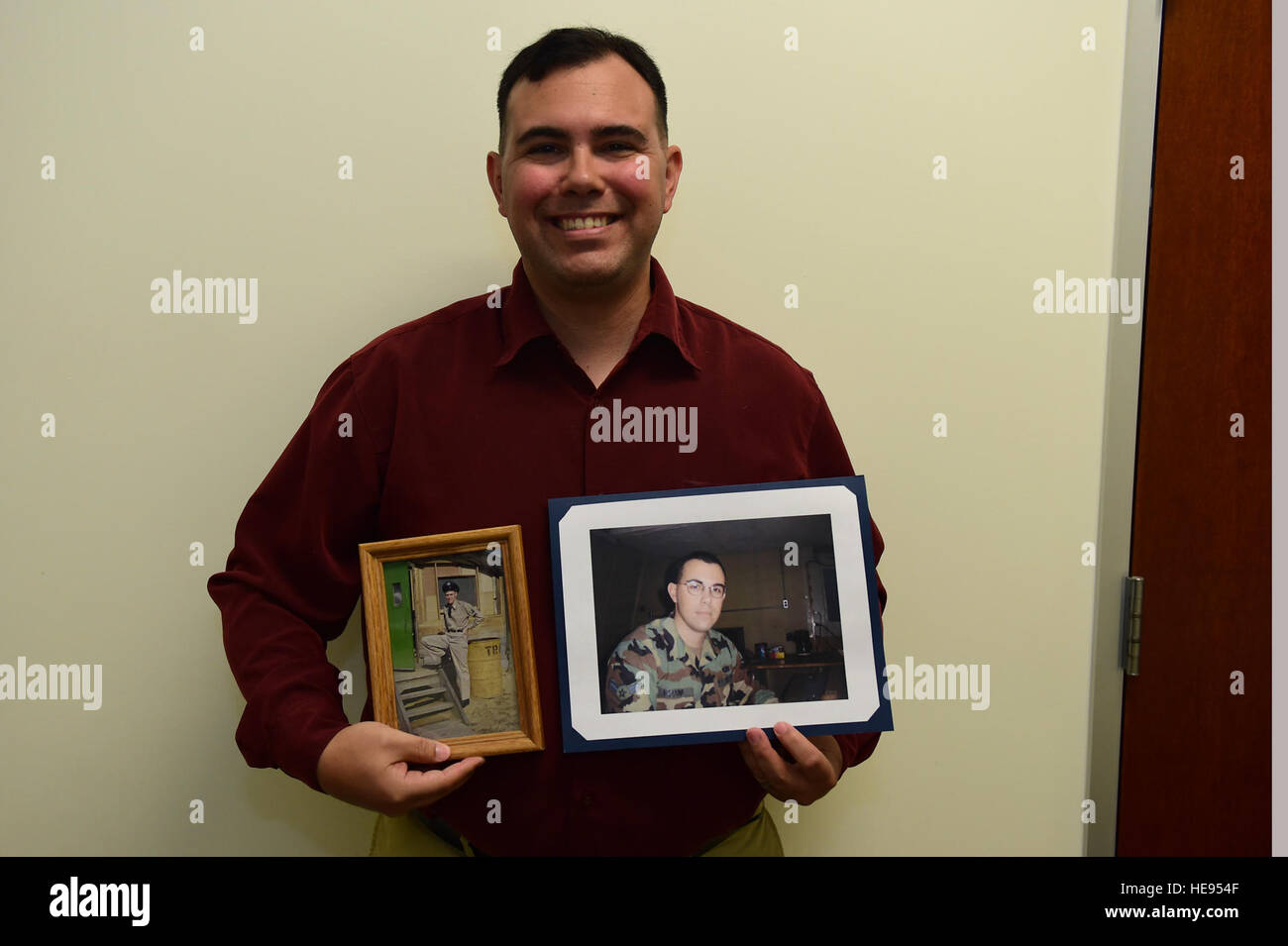 Christopher McCune, 460th Space Wing historian, displays photos of ...