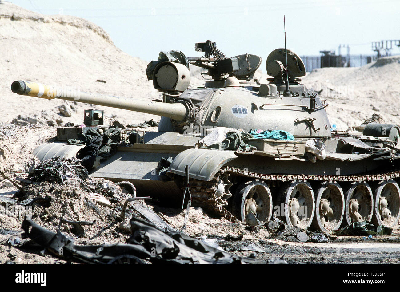 A demolished Iraqi T-55 main battle tank stands on a bank at Al Mutla ...