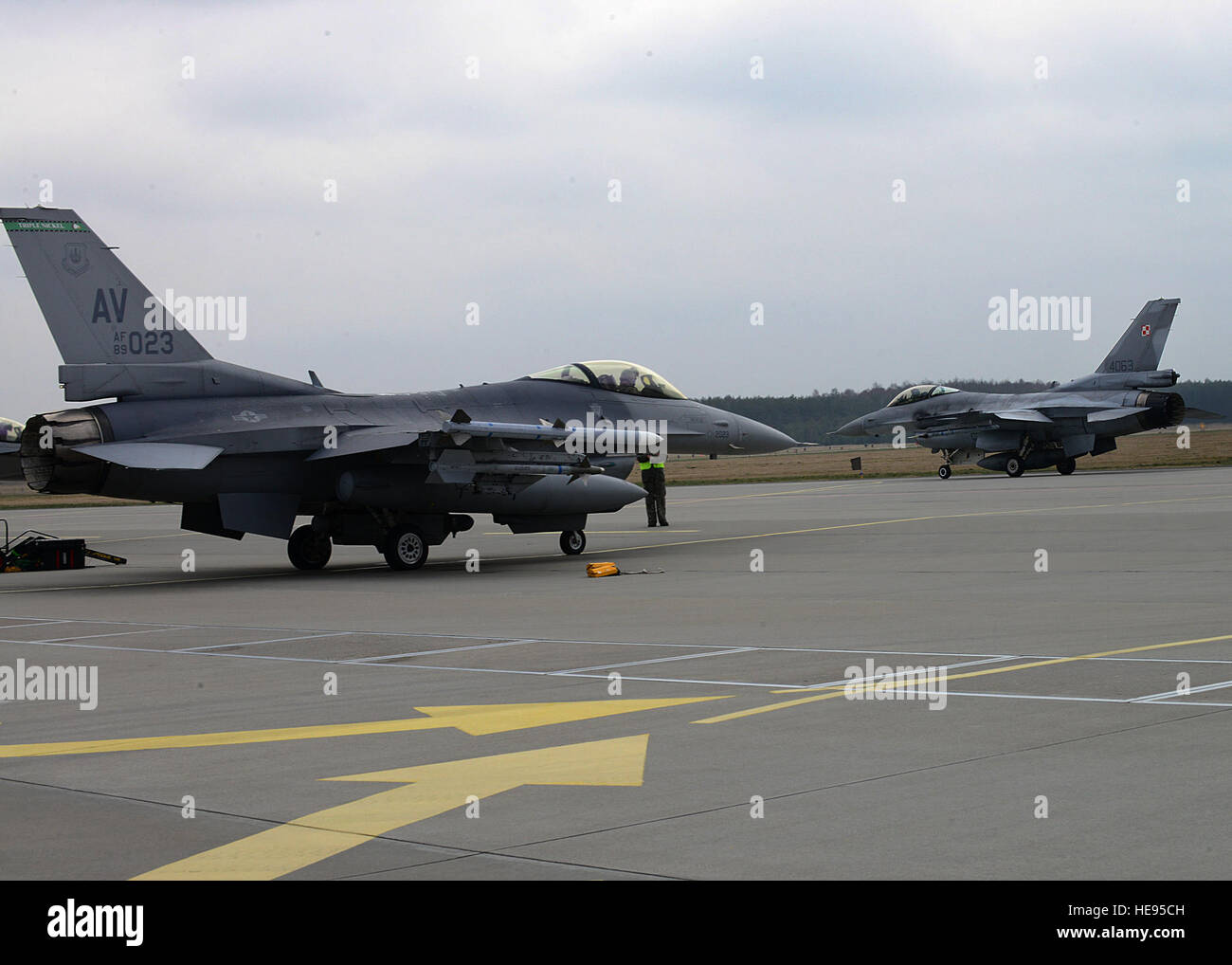A Polish F-16 Fighting Falcon aircraft, right, taxis past a U.S. Air ...