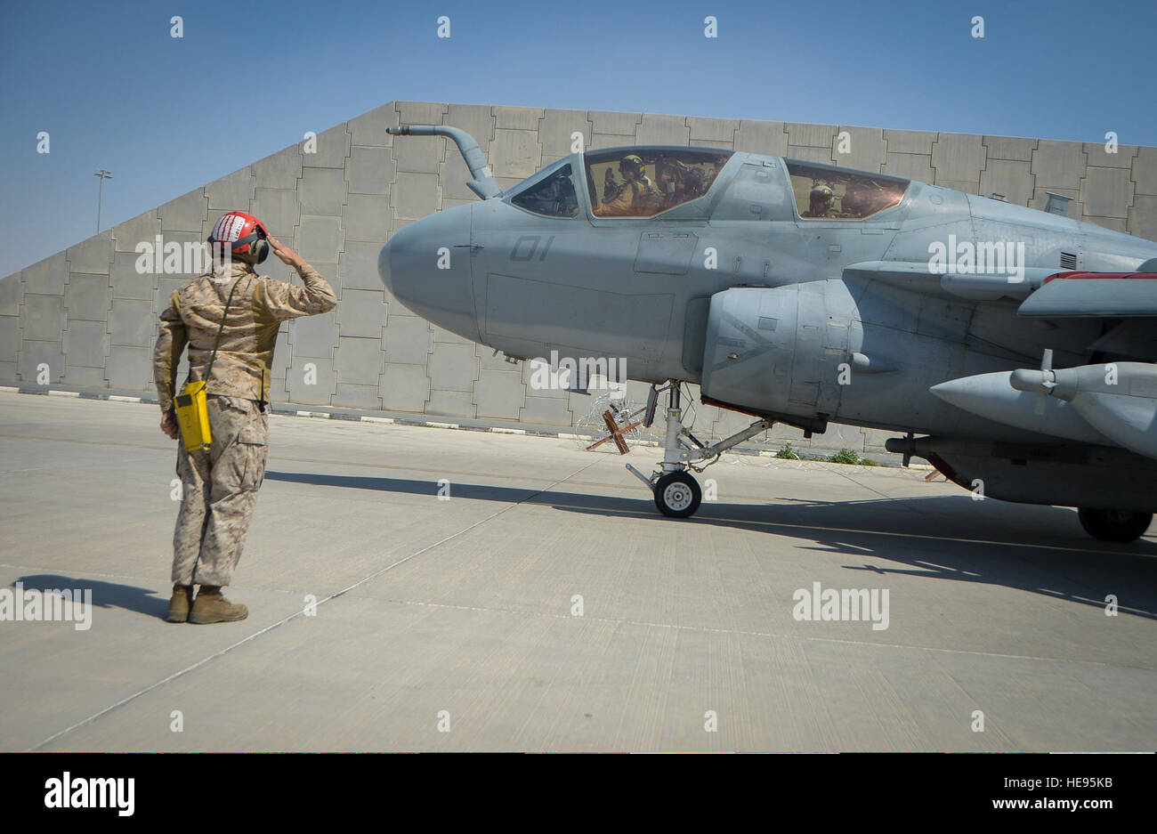 A U.S. Marine salutes a pilot assigned to Marine Tactical Electronic ...