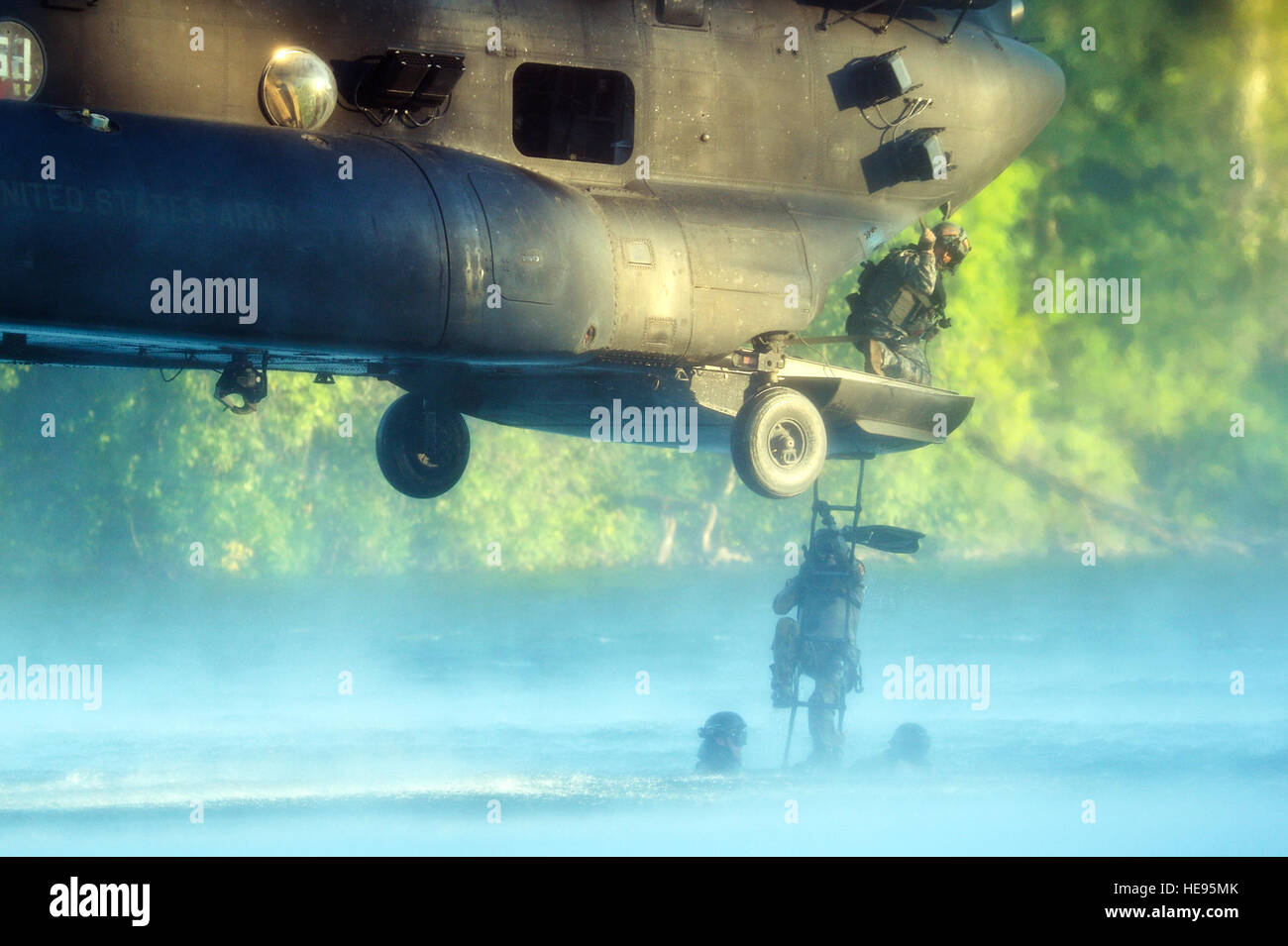 An Airman climbs a rope ladder into an MH-47 Chinook helicopter during ...