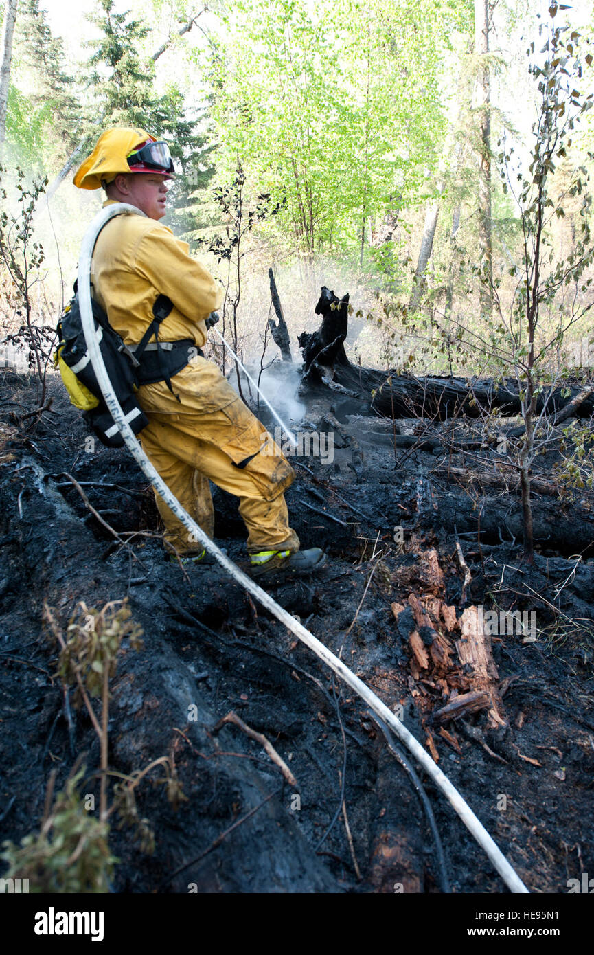 A firefighter from the 673rd Civil Engineer Squadron extinguishes ...