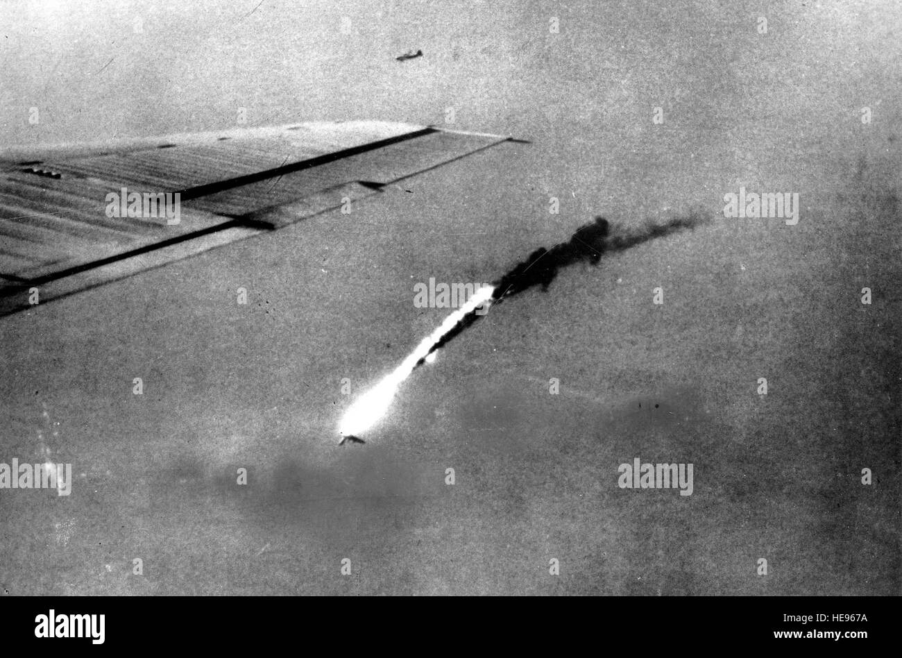 With one wing gone, a B-29 falls in flames after a direct hit by enemy ...