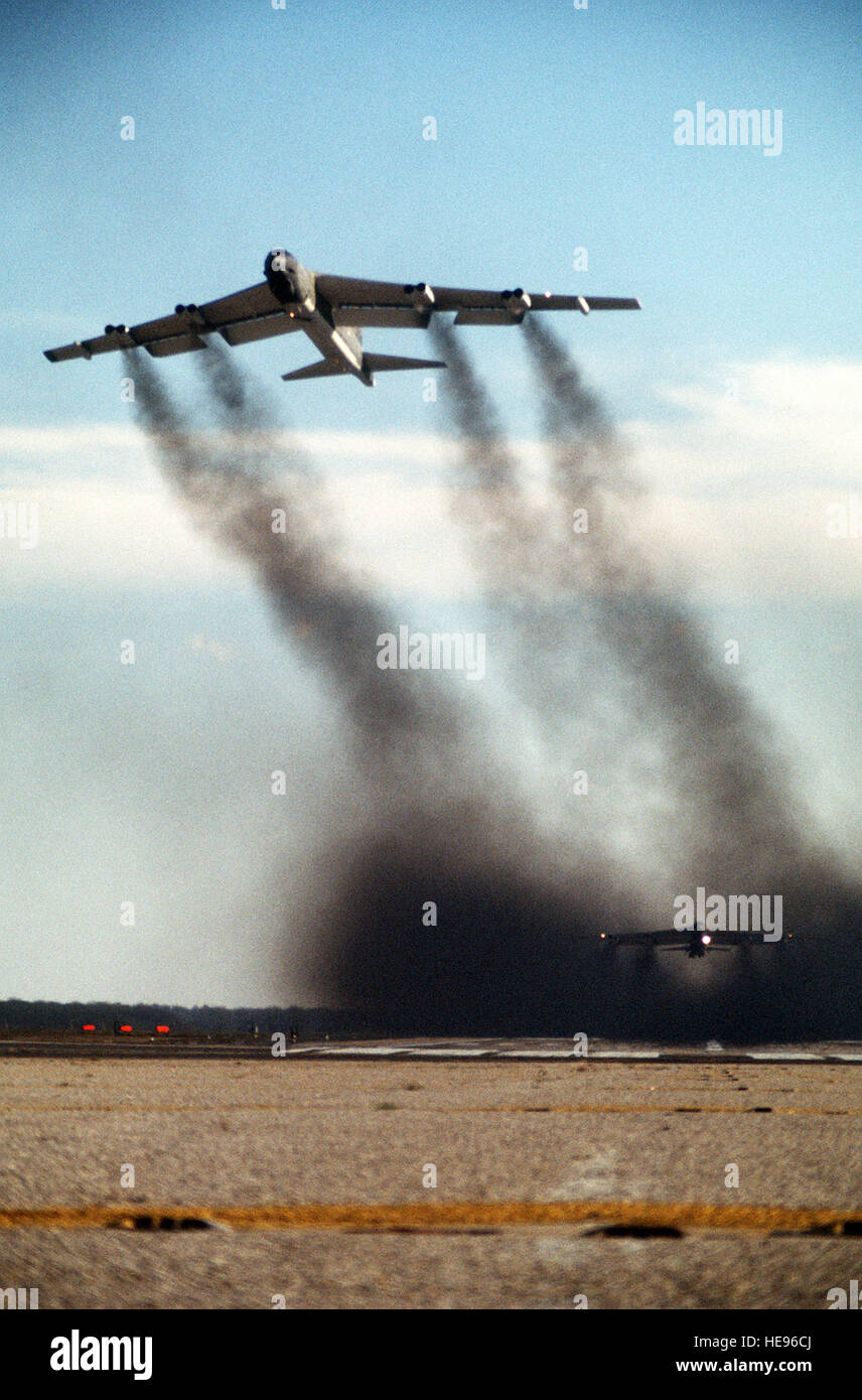 A B-52G Stratofortress aircraft takes off with another B-52G close ...